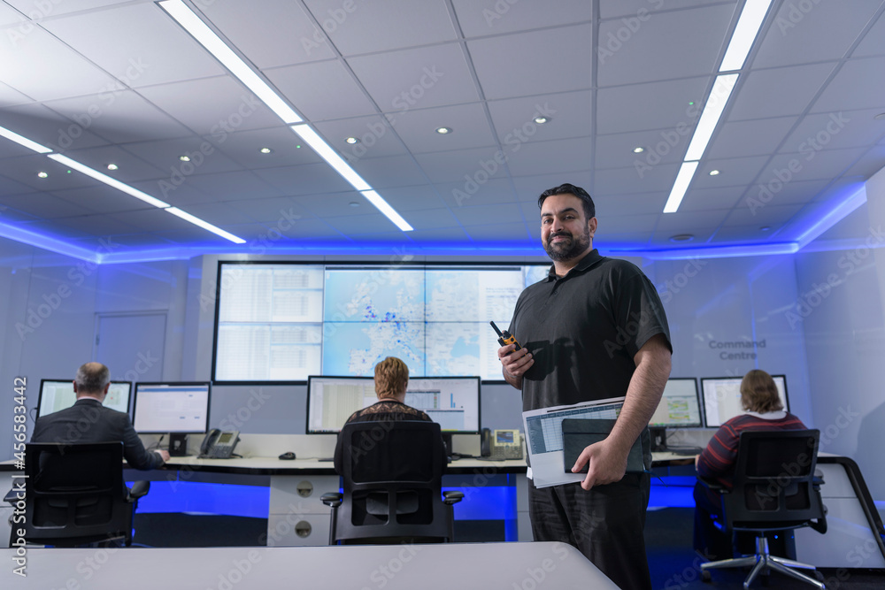 Portrait of operator in automotive emergency response control room in ...