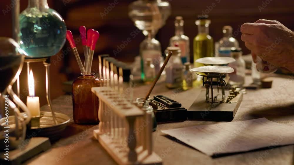A 19th century Apothecary in his laboratory using a balance scale to ...