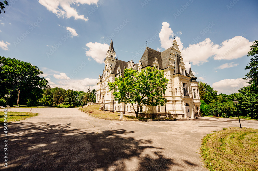Budmerice Castle from 19th century in nature landscape. Tree in forest ...