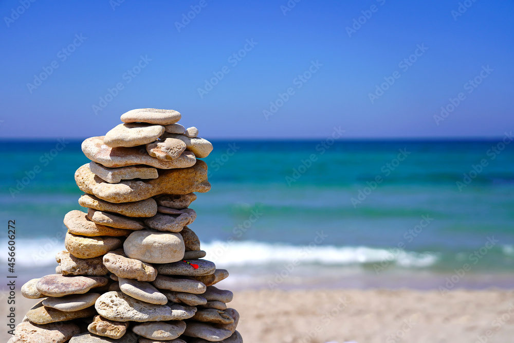 Big waves on the beach, the ocean. A pyramid of stones, pebbles, a ...