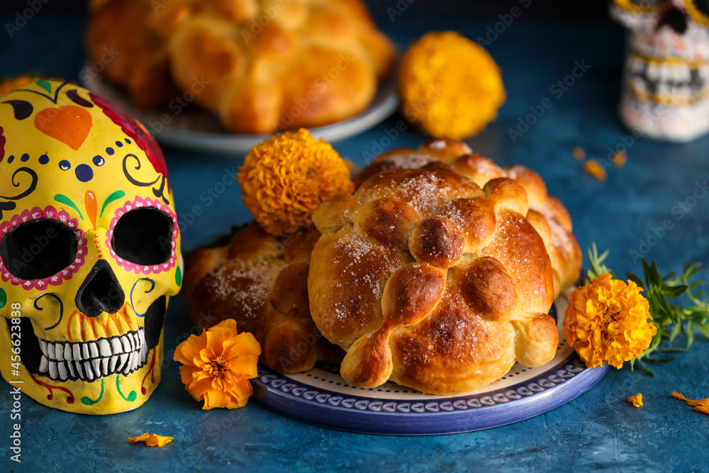 Bread of the dead and painted skull on color background. Celebration of ...