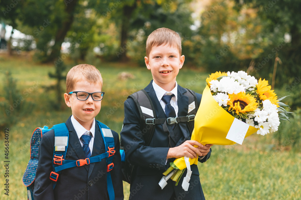 portrait of cute little seven year old boy first graders holding ...