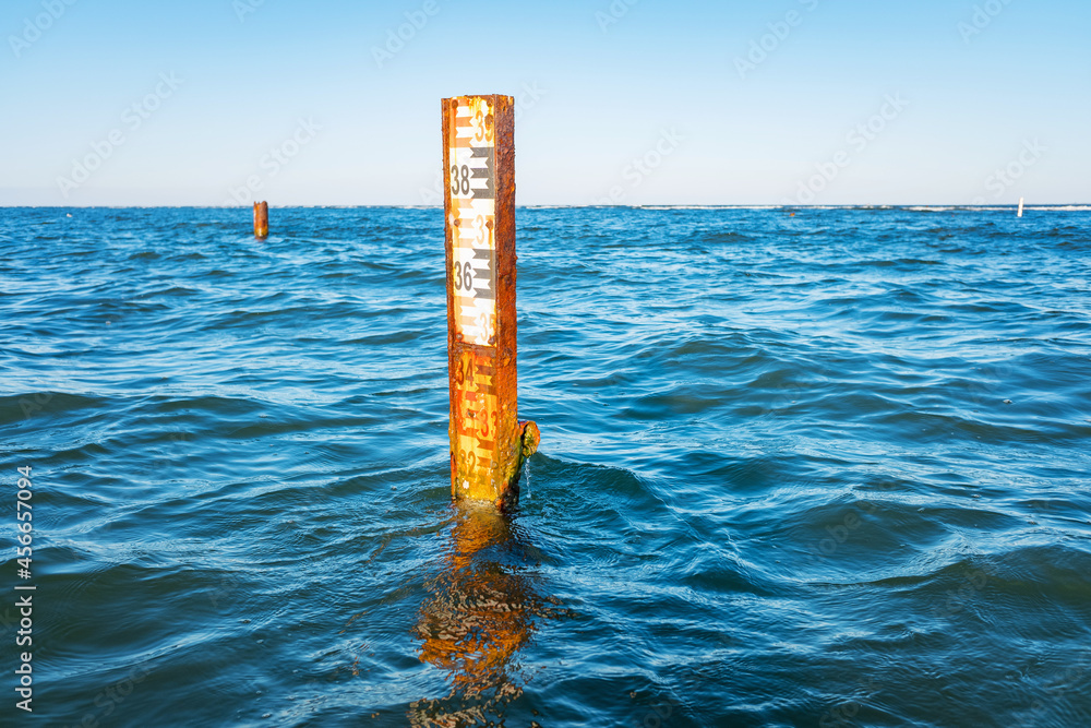 Water depth measurement tool or sea level marker. Observation of the ...