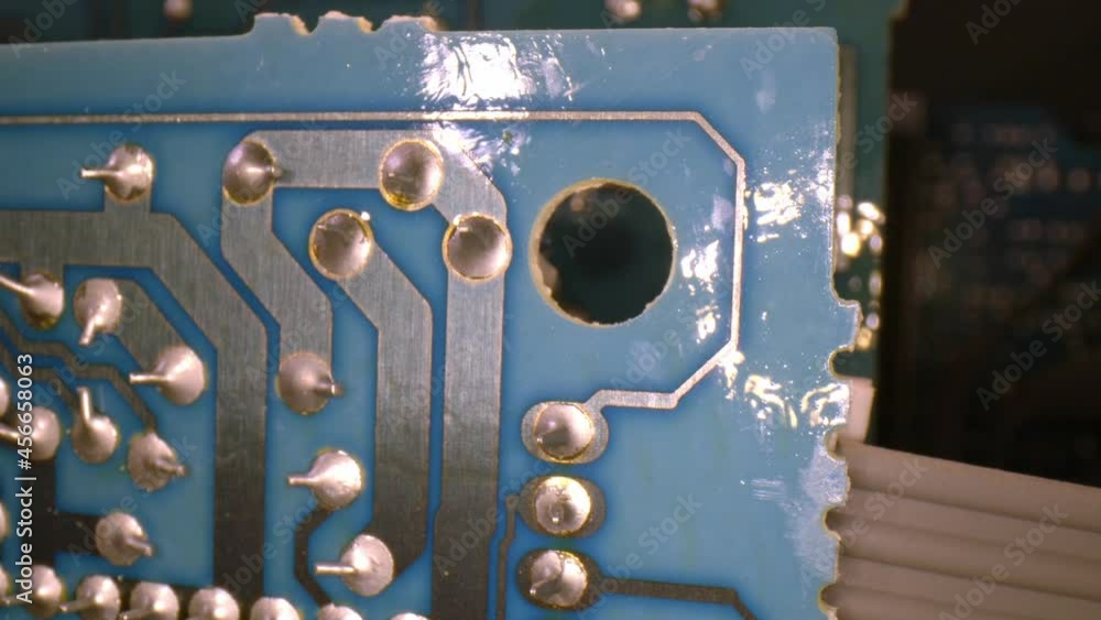 Macro view of large printed circuit board on soldered wire side. Slowly ...