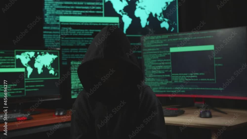 Hacker No Face Pose With Code On Multiple Computer Screens In Dark Room ...