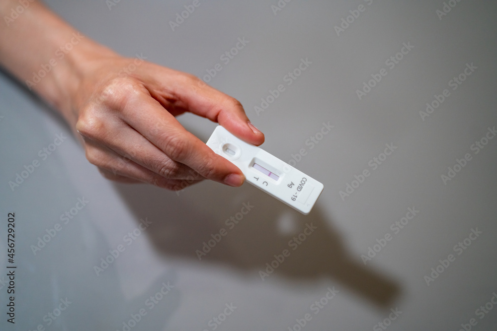 Asian woman using rapid antigen test kit for self test COVID-19 ...