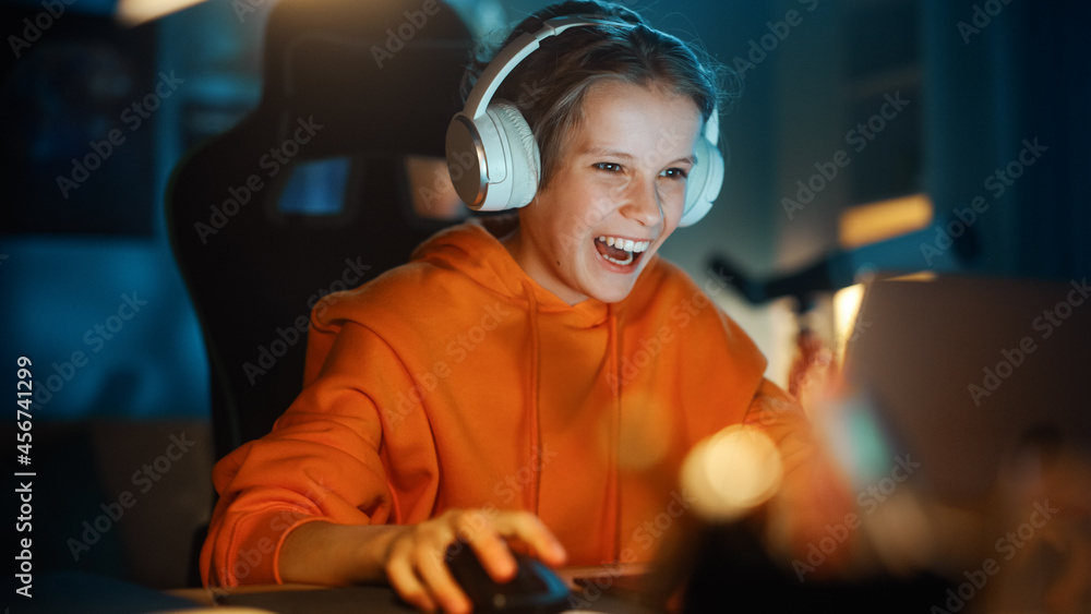 Excited Young Boy in Headphones Playing Video Games on Laptop Computer ...