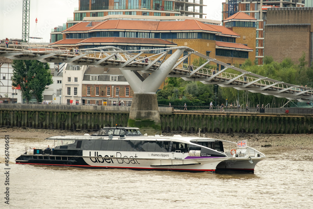 Foto de London, September, 2021: Uber River Boat going under the ...