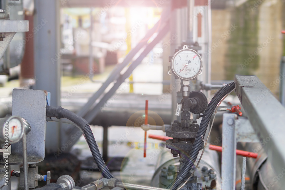 Industrial pressure gauge on the background of a chemical plant ...