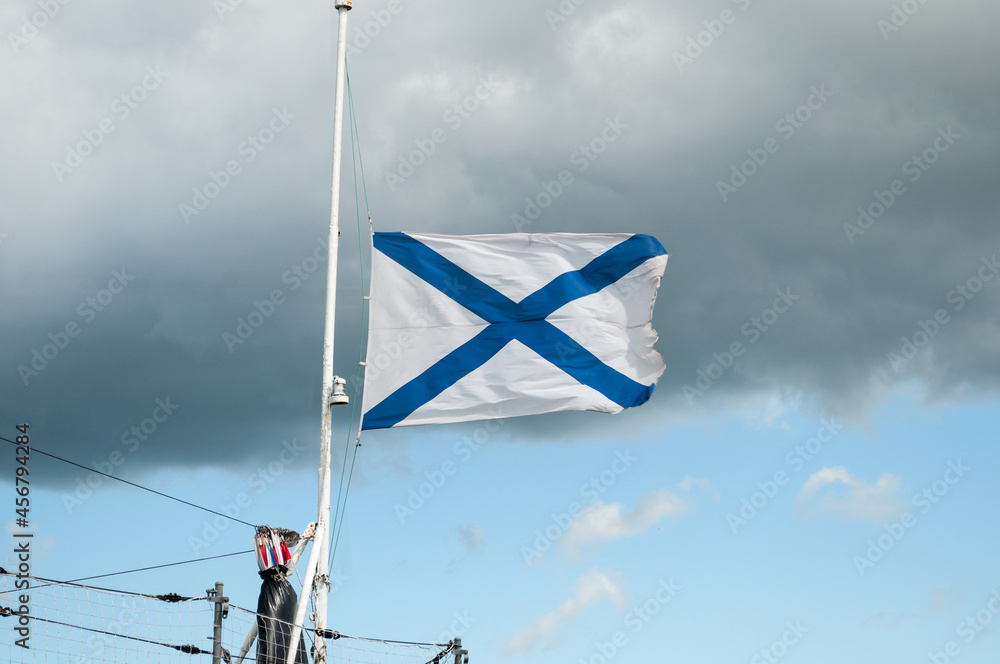 The St. Andrew's flag is flying in a strong wind. The St. Andrew's ...