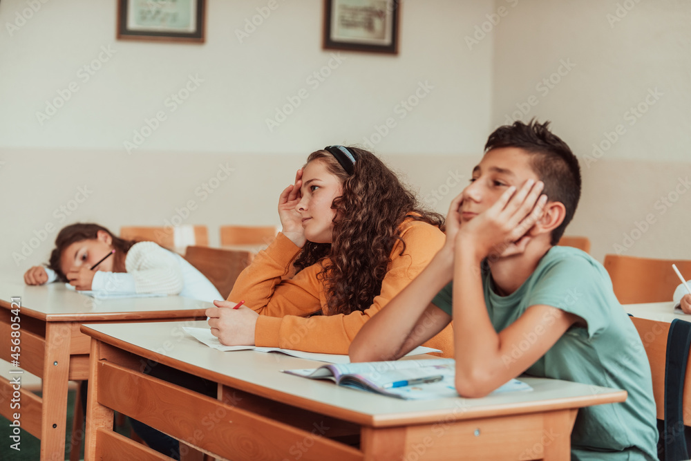 tired young students sit in the classroom and attend school. Selecttive ...