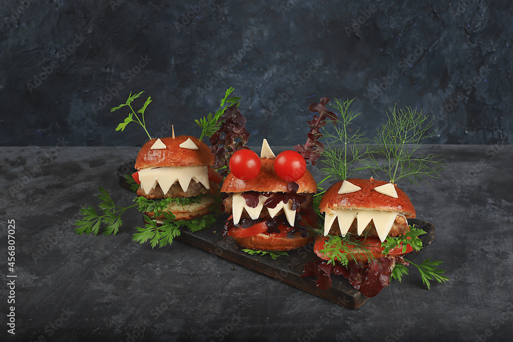 Halloween food concept. Scary burgers with fresh parsley leaves ...