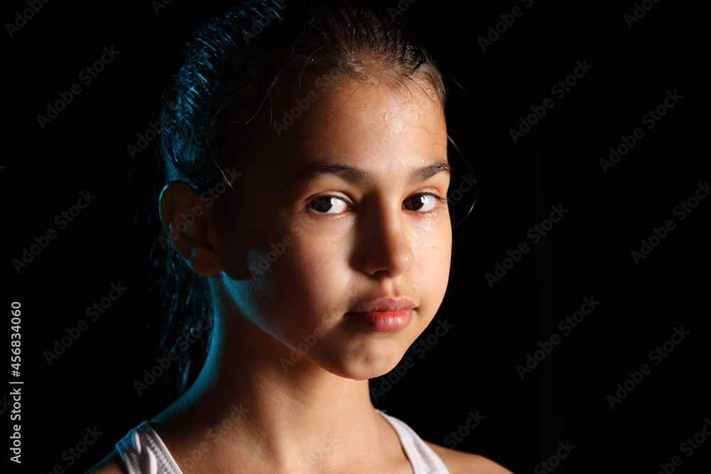 Close-up portrait of a bright beautiful girl swimmer 12 years old on a ...