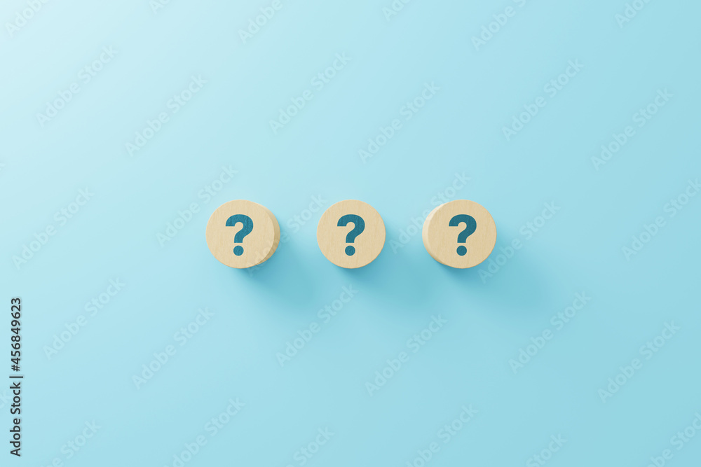Wooden block shape with sign question mark symbol on blue background ...
