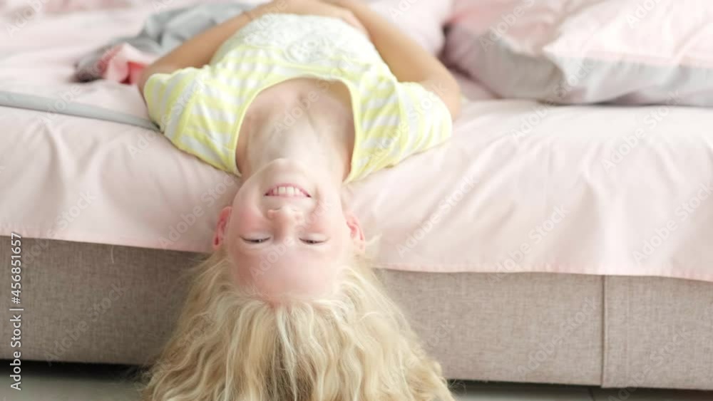 Portrait handsome cute little blonde girl having fun in bed in the ...