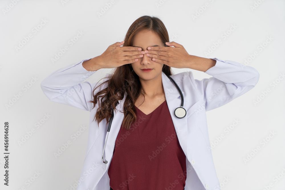 female doctor wearing white suit uniform closing eyes with both hands ...