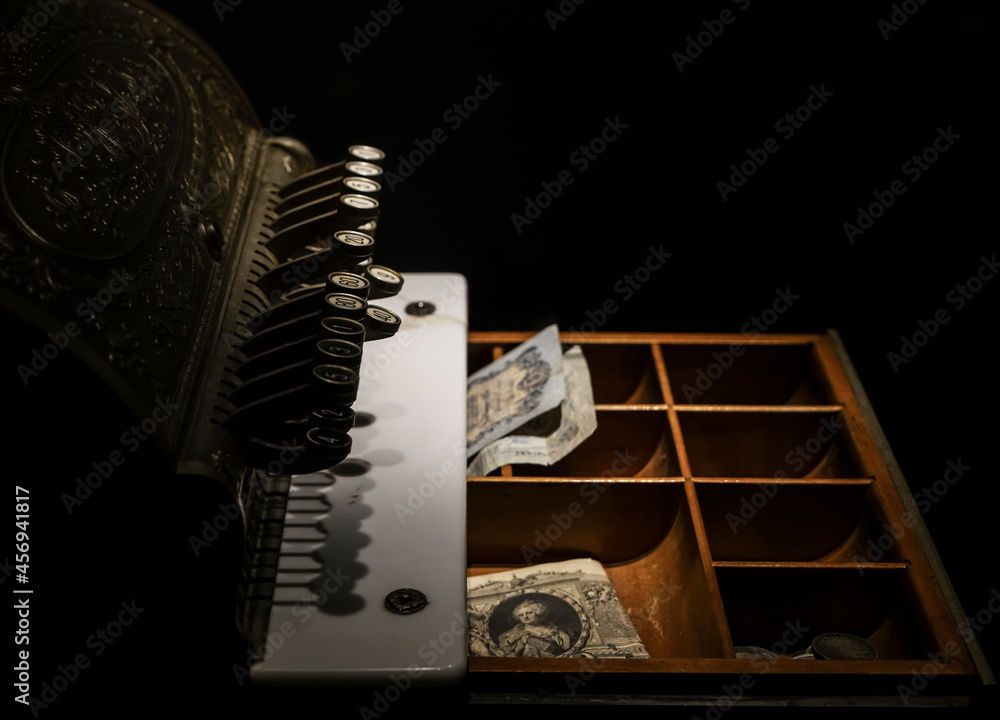 Antique cash register. Old-time cash register in a shop. Cash and coins ...