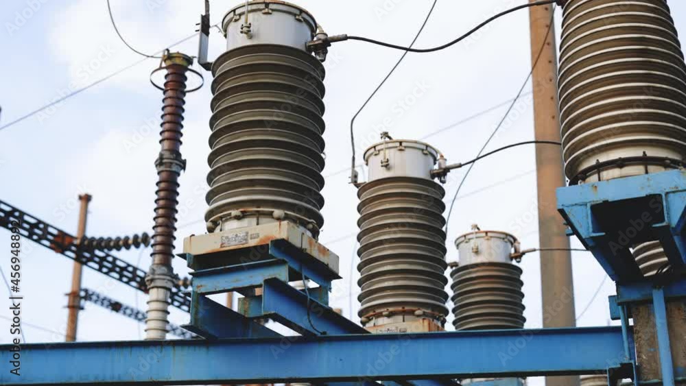 High voltage substation with tall pylons and voltage distribution ...