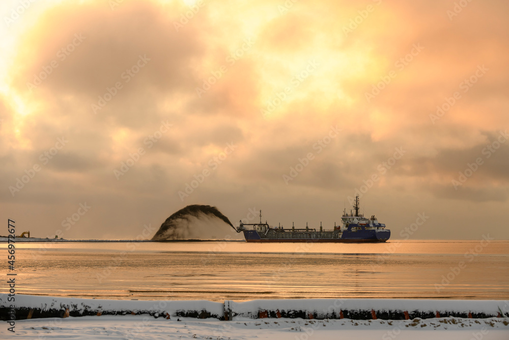 Vessel engaged in dredging. Dredger working at sea. Ship excavating ...