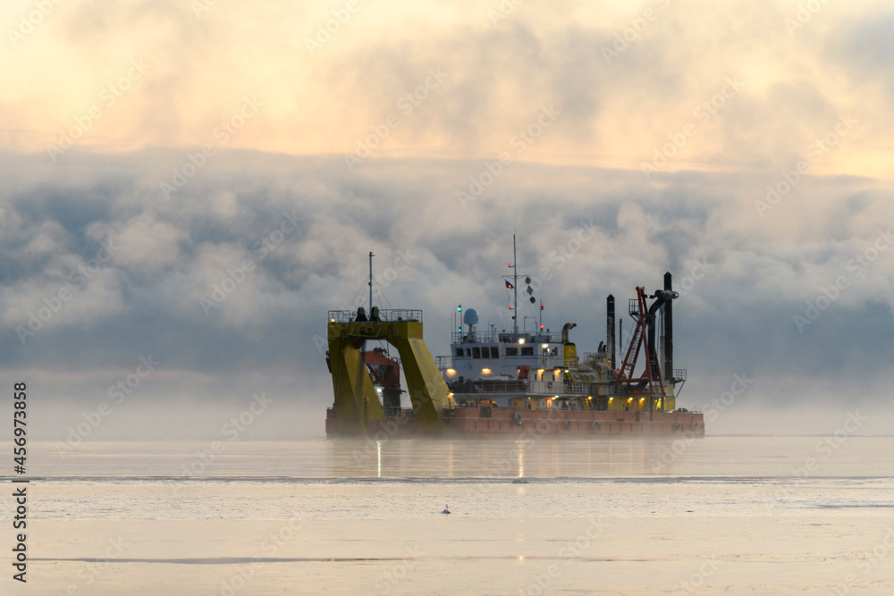 Vessel engaged in dredging. Dredger working at sea. Ship excavating ...