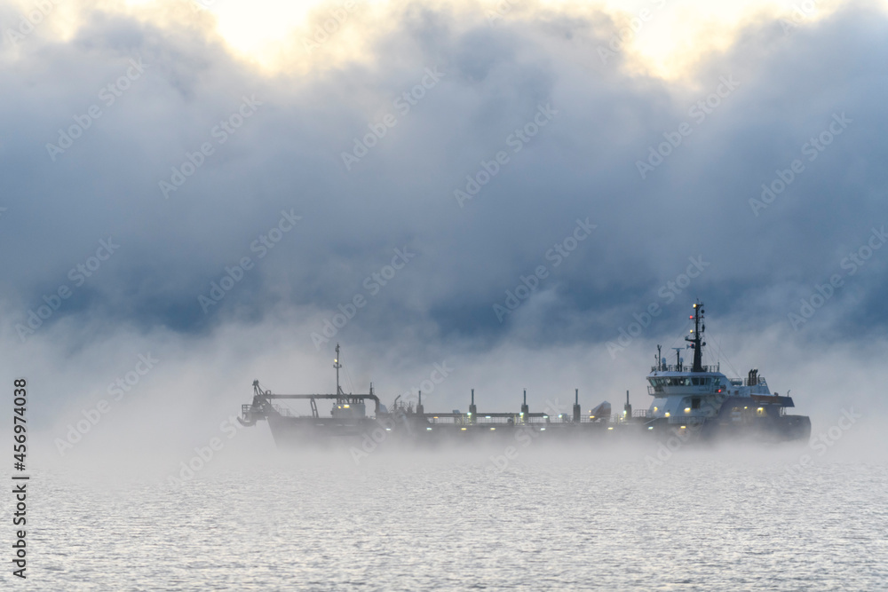 Vessel engaged in dredging. Dredger working at sea. Ship excavating ...