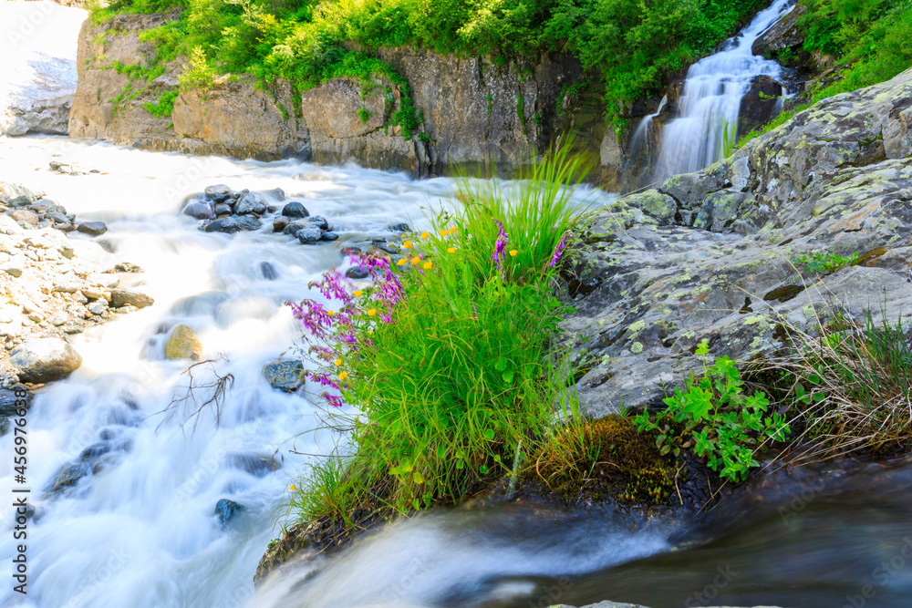 Spring streams of water and waterfalls on mountain streams in Dombay ...