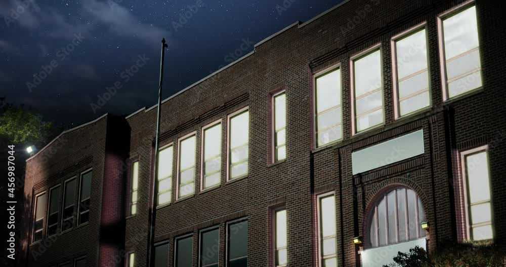 A night establishing shot of a typical small town two-story red brick ...