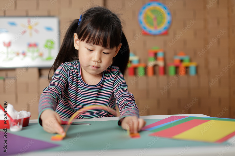 young girl making paper craft for homeschooling Stock Photo | Adobe Stock