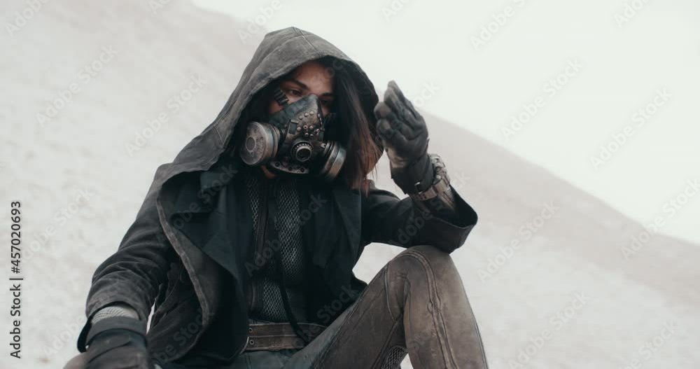 Post apocalyptic female wanderer wearing grunge hooded mantle gas mask ...