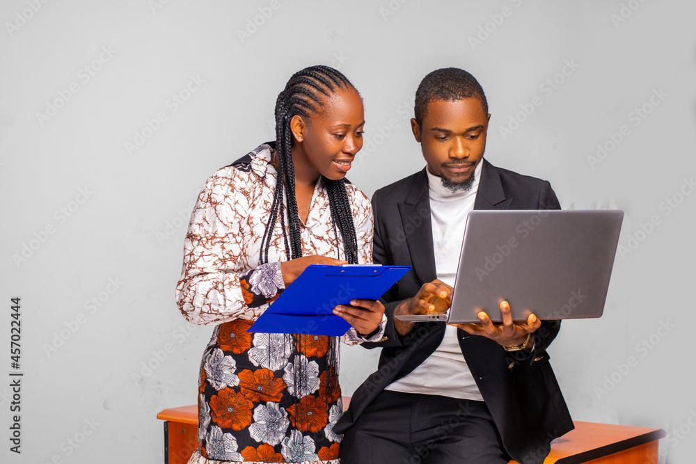 handsome manager and his co worker working on their business plan Stock ...