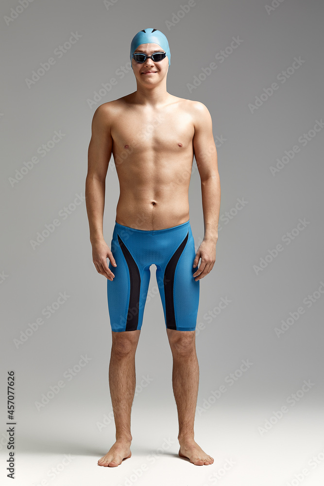 Portrait of a swimmer in a cap and mask, full-length portrait, young ...