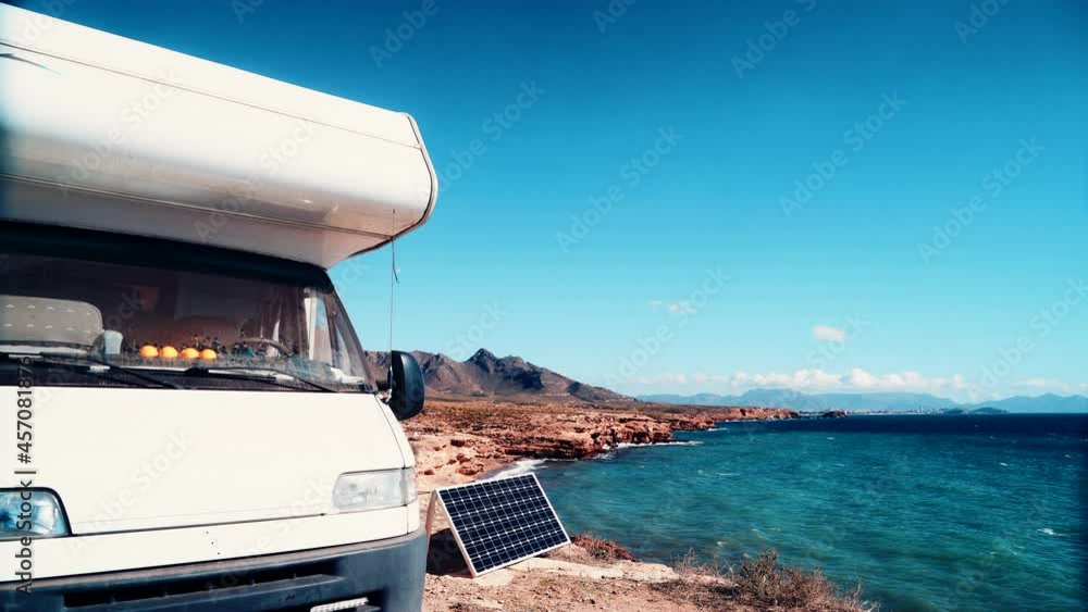Charging battery at camper car. Caravan with portable solar ...
