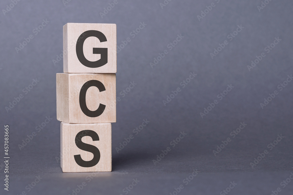 GCS (Glasgow Coma Scale) - text, written on wooden blocks, on gray ...
