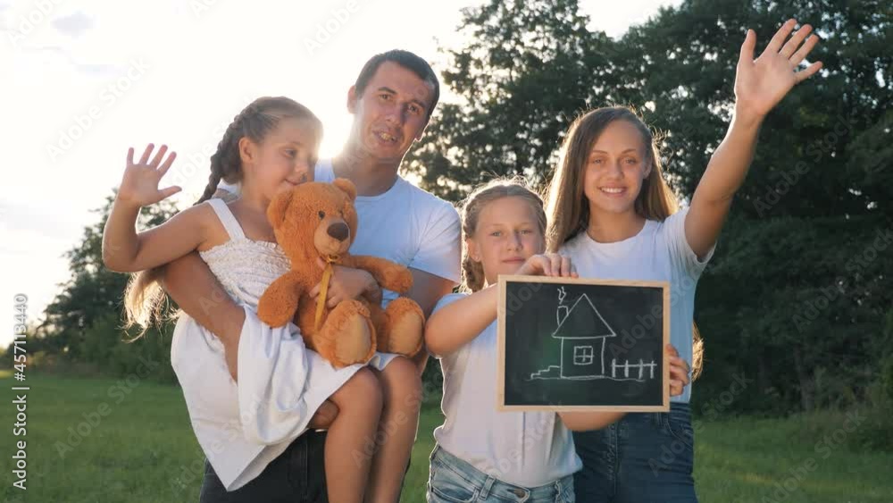 Happy family greets with smile, looks into camera.People welcome to ...