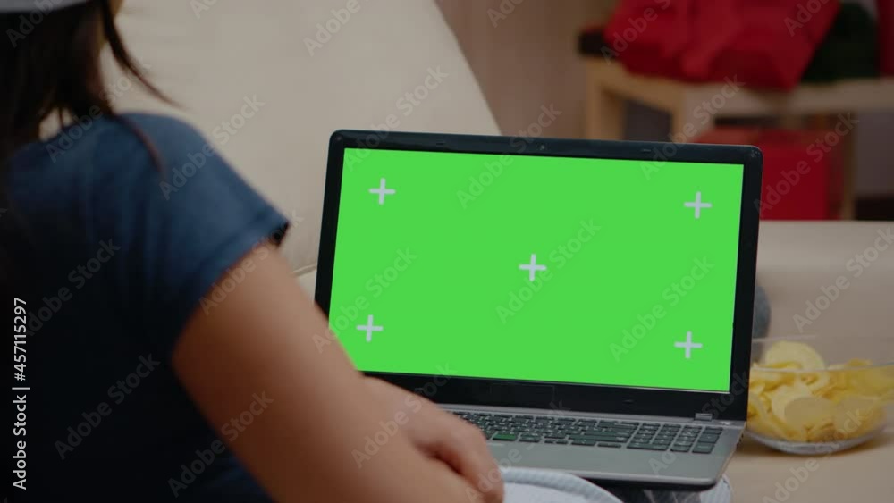 Close up of person watching horizontal green screen on laptop. Woman ...