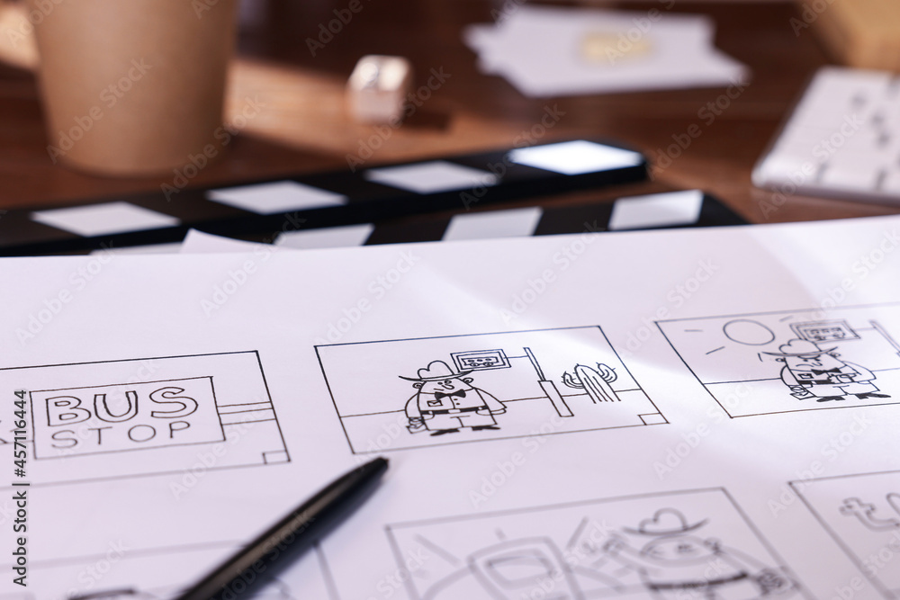 Storyboard with cartoon sketches at workplace, closeup. Pre-production ...