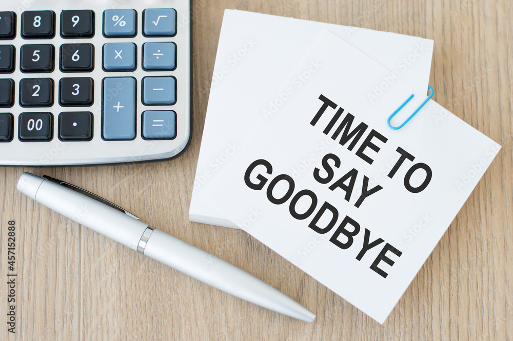 Time to say goodbye written on a white note card on the table next to a ...