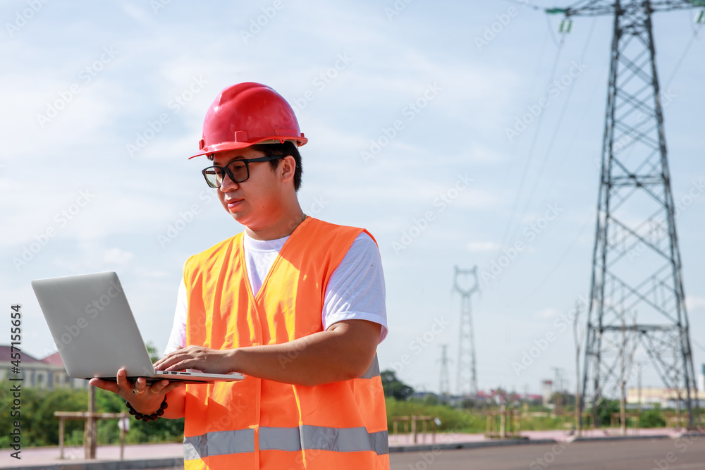 Asian electrical engineers worker in standard safety uniform using a ...