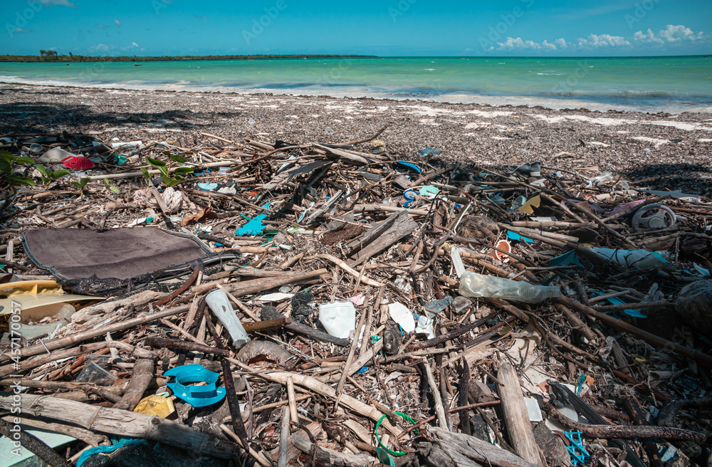 Spilled garbage on the beach of tropical island. Trash on the beach ...