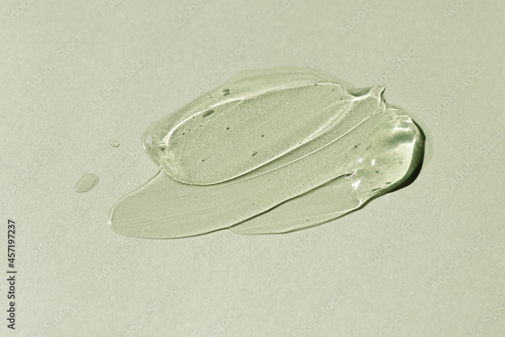Liquid gel smear isolated on grey green background. Beauty cosmetic ...