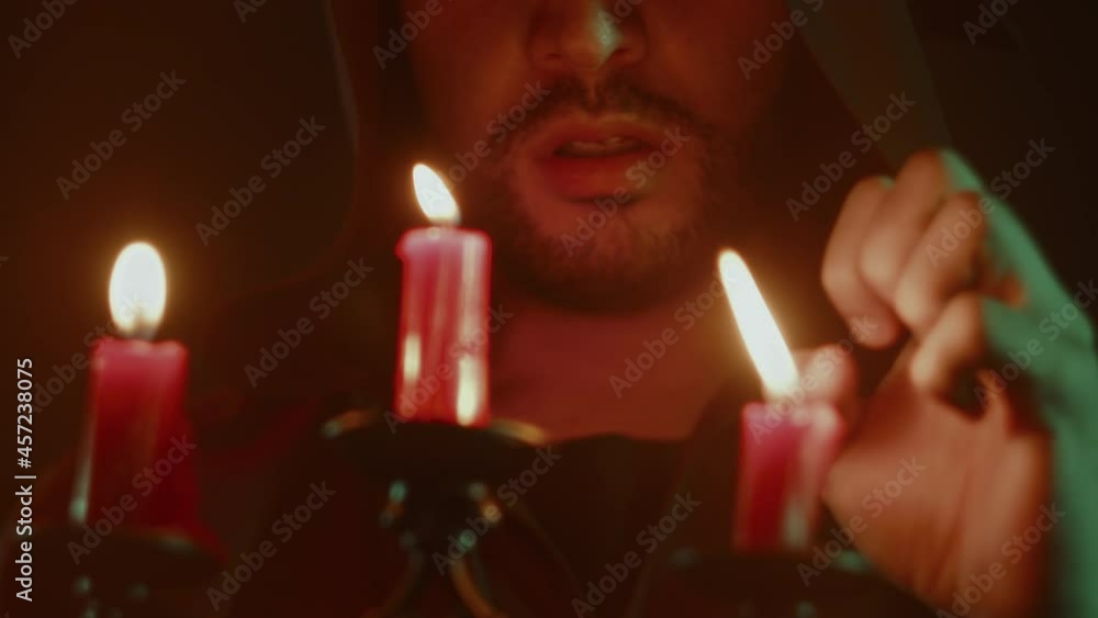 Evil sorcerer conjuring with burning candles, reading spell. Wicked ...