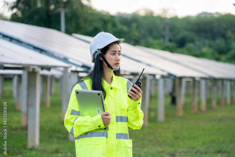 Engineer women wearing safety vest and safety helmet use radio Stock ...