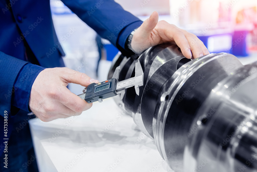 Foto de Engineer checks dimensions with vernier caliper control quality ...