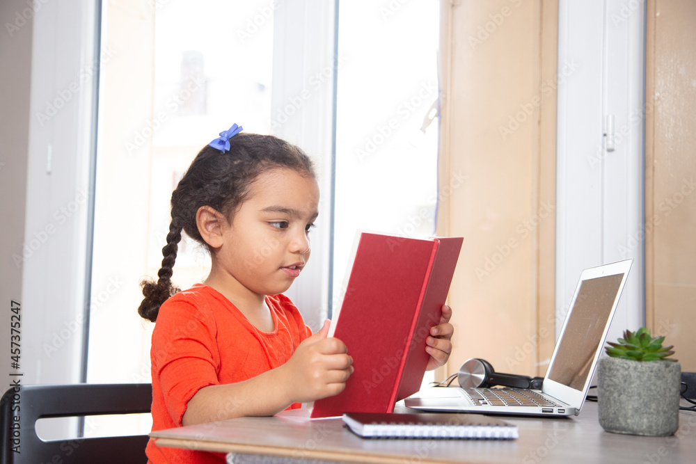 baby studying at home with his laptop and headphones . distance ...
