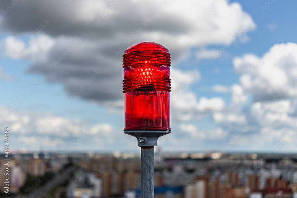 Red signal beacon. Signal lights on the roof of a multi-storey building ...