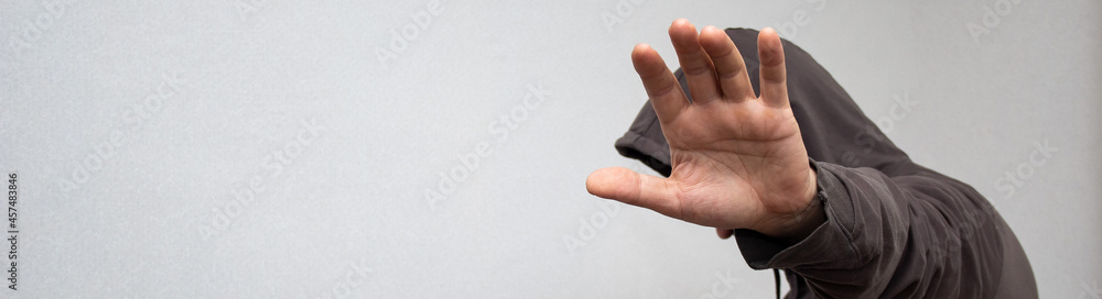 banner of Man in grey hood hiding his face with the hands, show stop ...