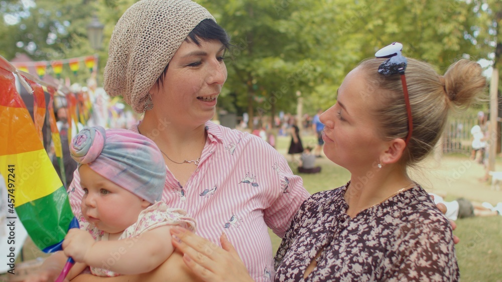 Happy LGBT family with baby on Pride festival to commemorate the ...