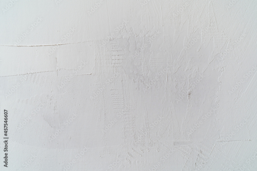 White textured putty on the wall, rough application. cement and ...