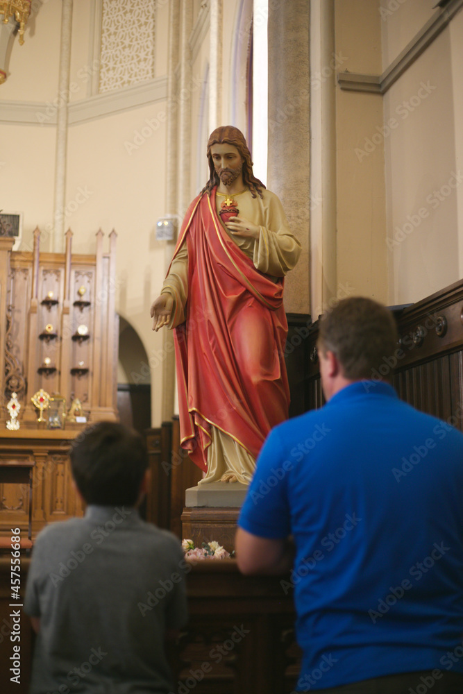 Father and son in front of Sacred Heart of Jesus Statue in a Catholic ...