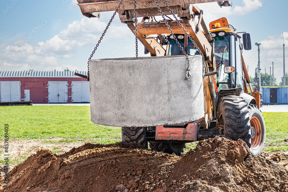 Hydraulic piston system of the excavator with a bucket, lowering into ...